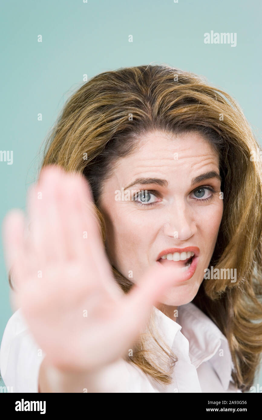 Portrait of a mid adult woman showing a Stop hand gesture Stock Photo ...