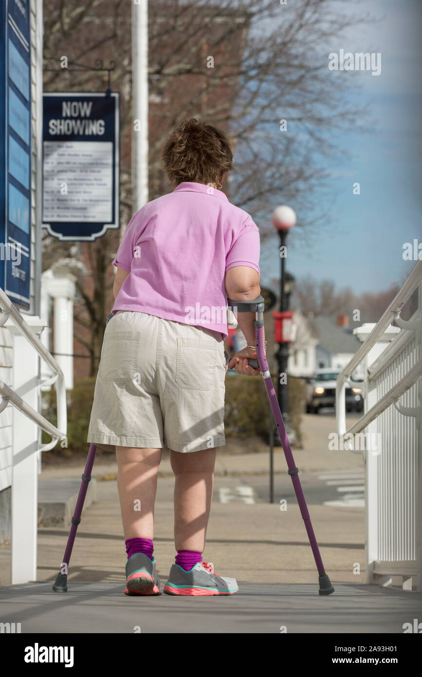 Woman with Cerebral Palsy walking down an accessible ramp Stock Photo ...