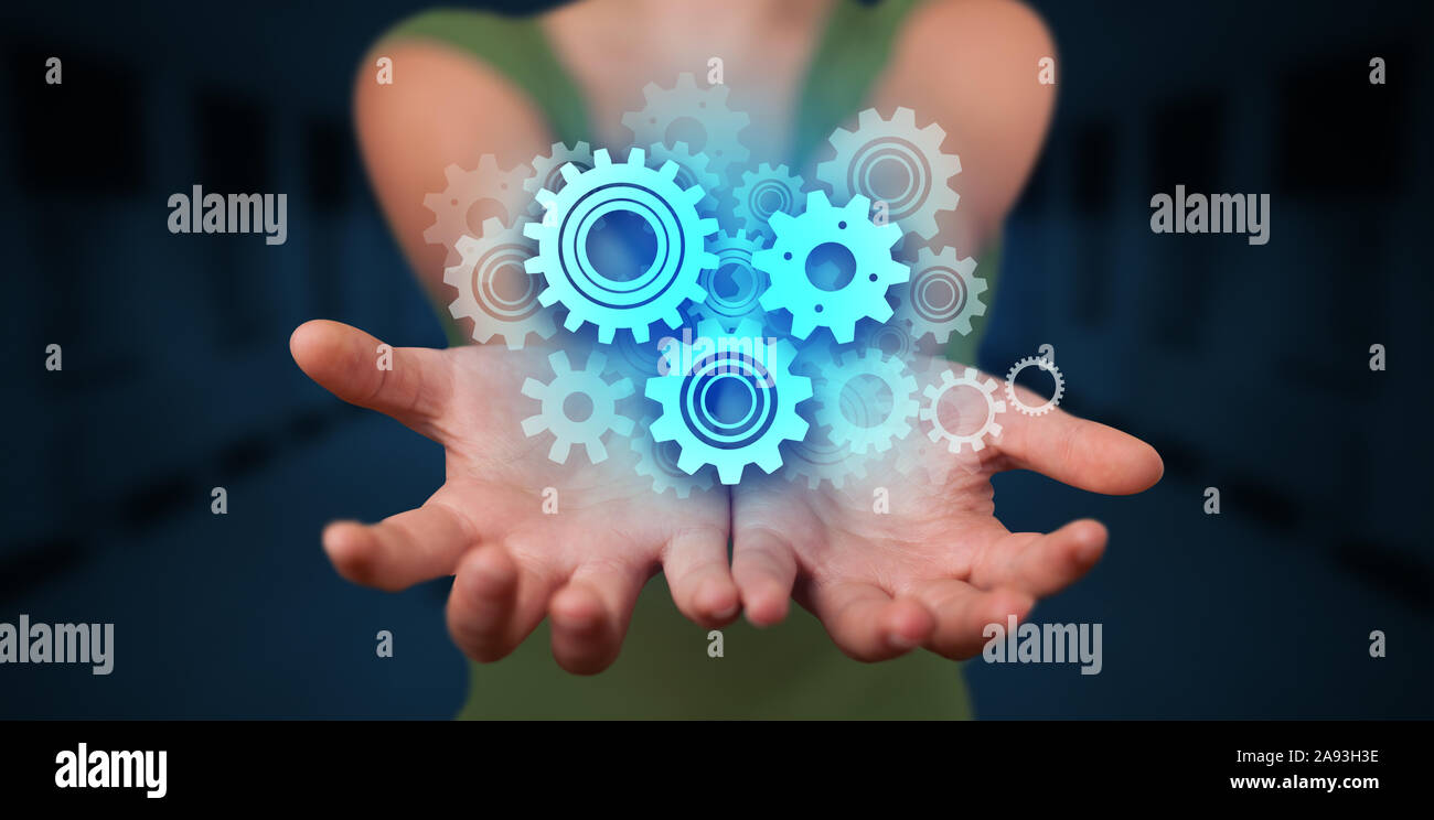 Hand holding gears in his hand Stock Photo - Alamy