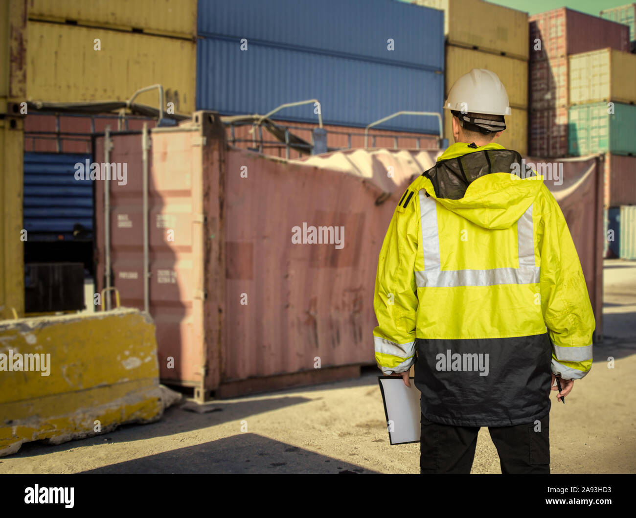 Ship supervisor engineer inspector stands at the dockside in a port ...