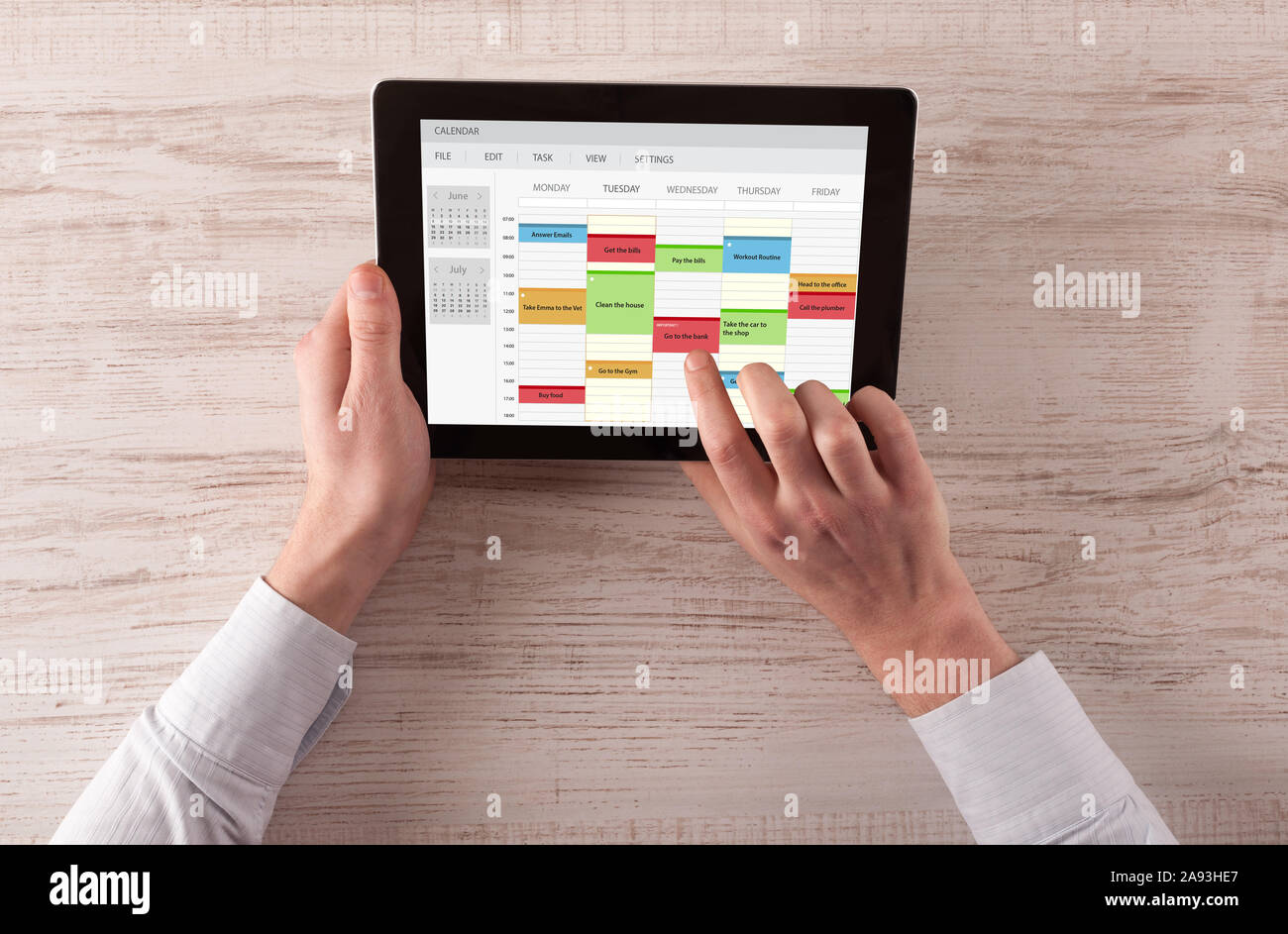 Hand holding tablet with timetable and calendar concept Stock Photo - Alamy