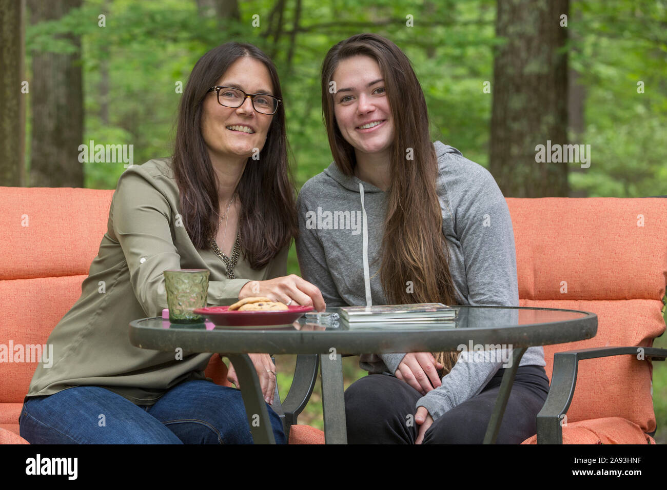 Happy woman with Multiple Sclerosis sitting with her daughter Stock ...