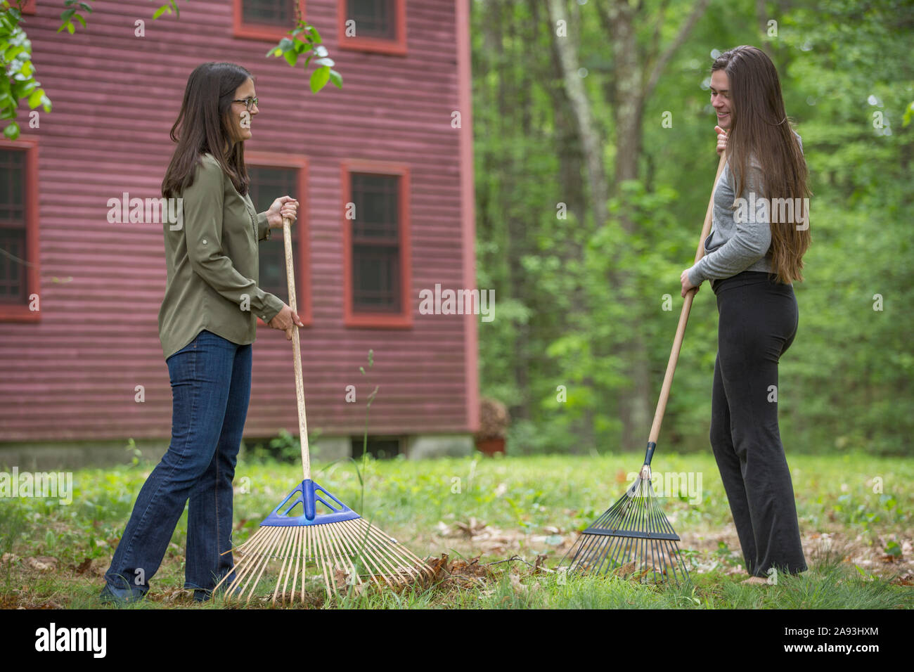 Woman with Multiple Sclerosis and her daughter raking leaves Stock ...