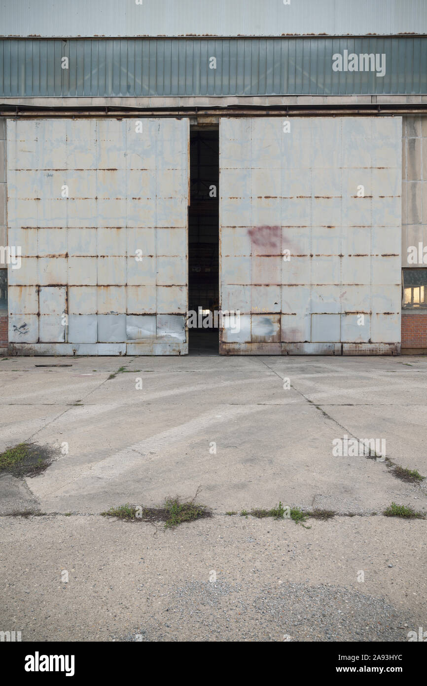 large industrial metal door from an abandoned factory Stock Photo - Alamy