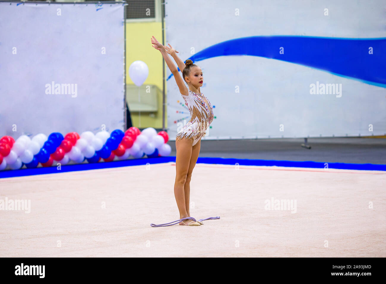 Adorable girl with jump rope competing in rhythmic gymnastics Stock ...