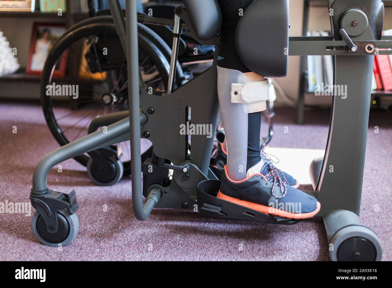 Woman with spinal cord injury getting into her desk so she can stand up ...
