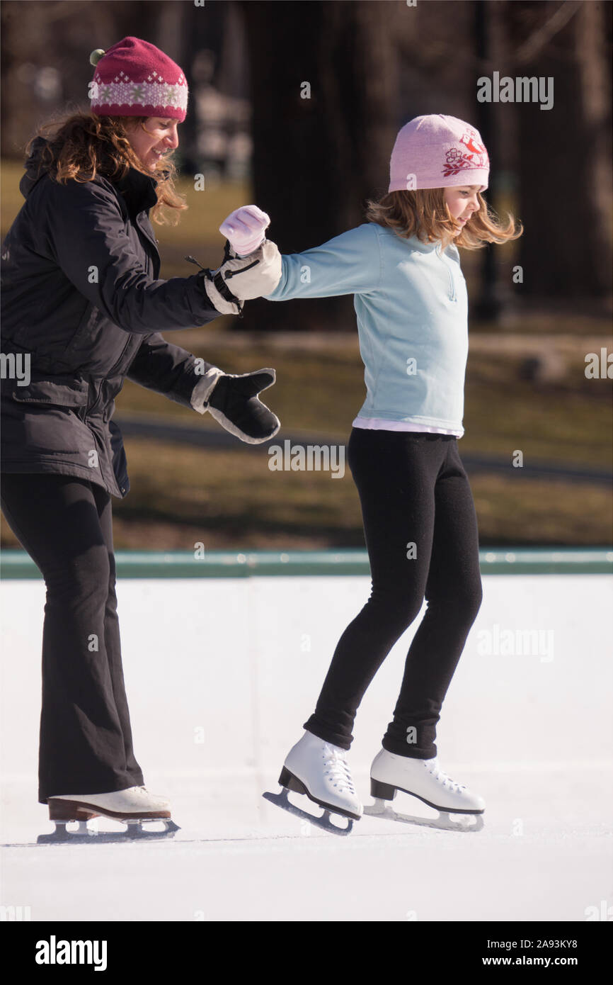 Female coach helping girl learn to figure-skate Stock Photo - Alamy