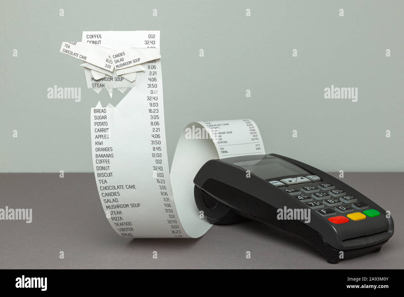 Angry paper bill. Pos terminal with paper tape on a gray background ...