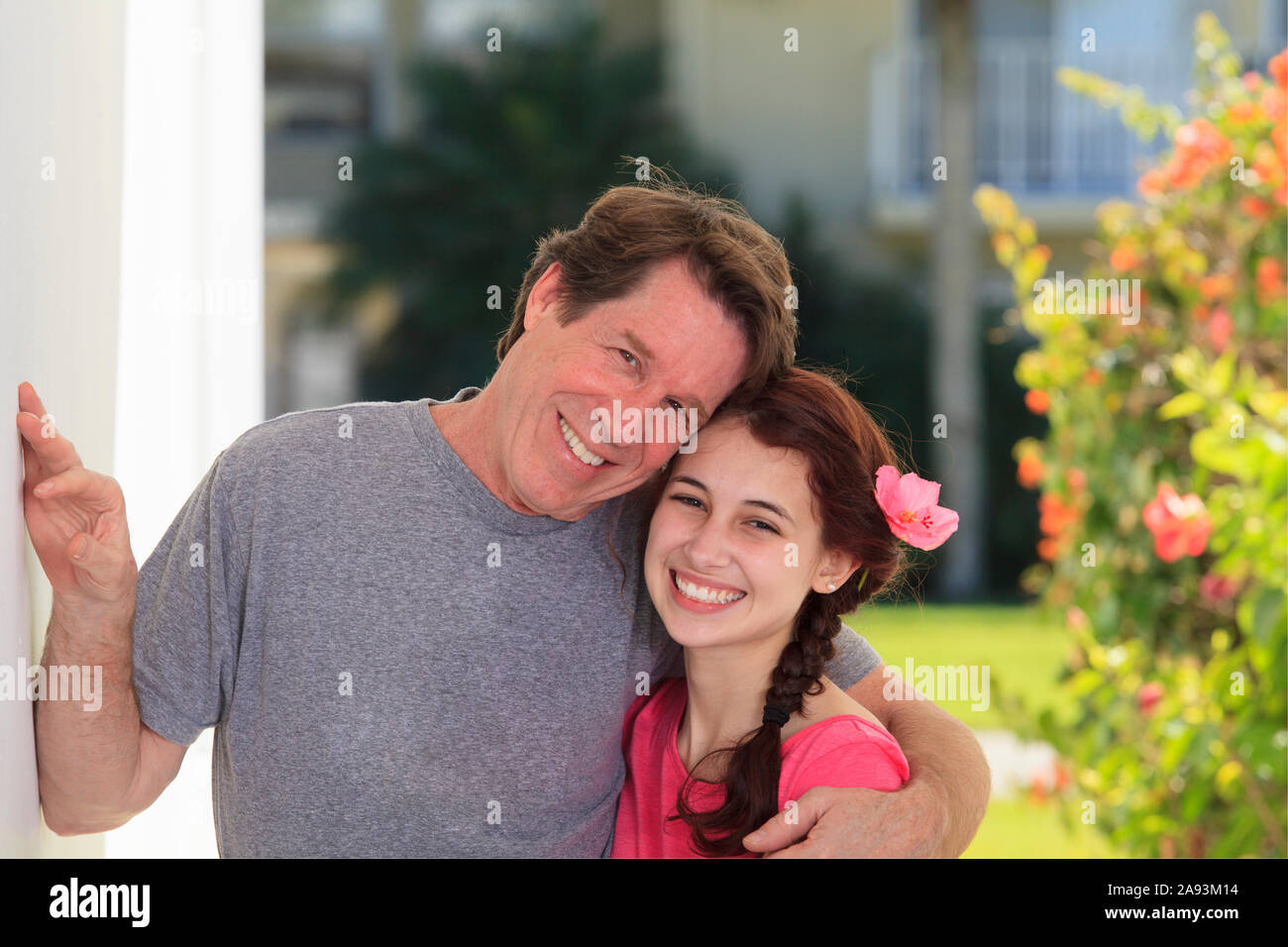 Smiling father hugging his daughter Stock Photo - Alamy