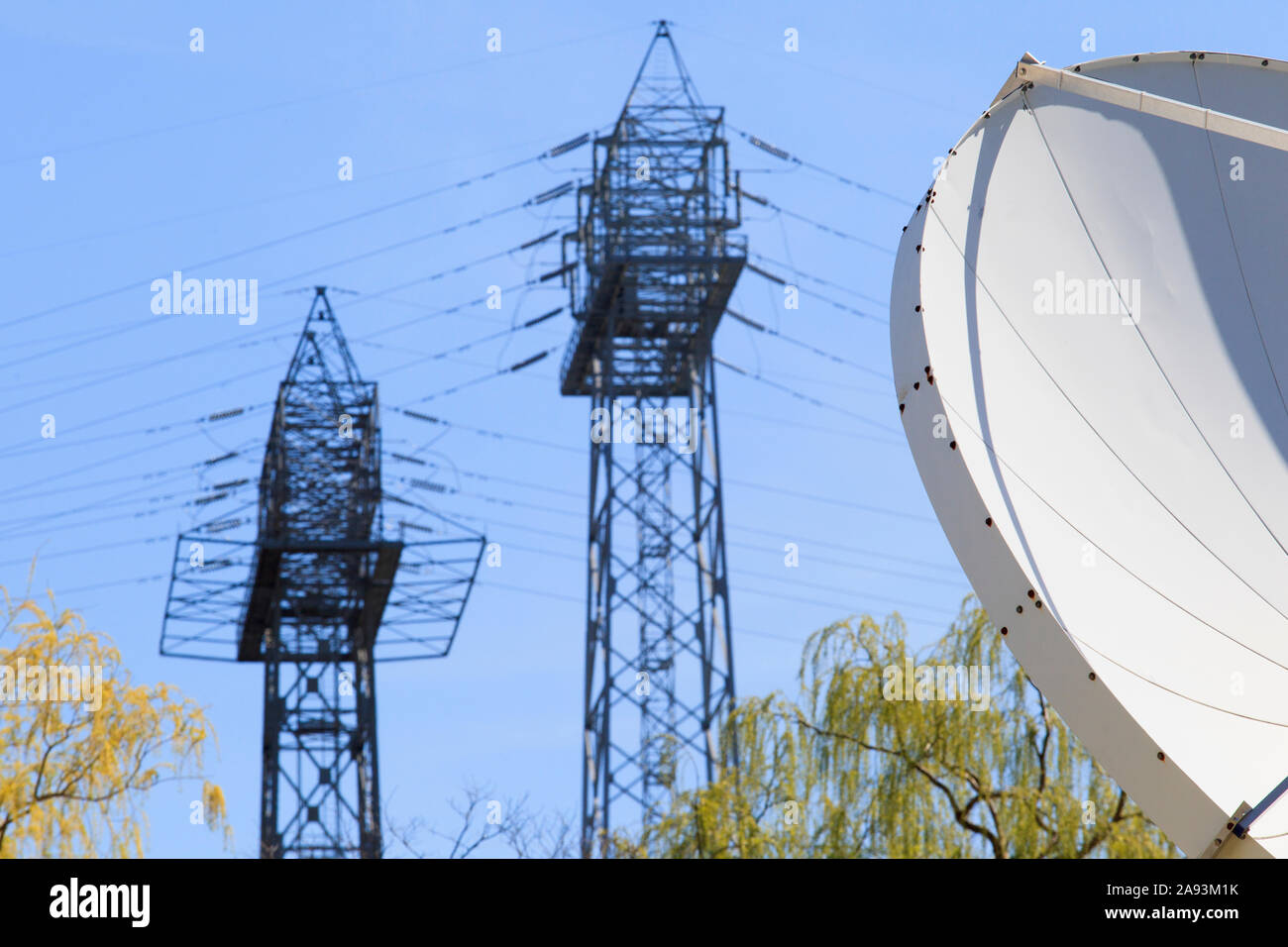 Satellite dish and power transmission towers Stock Photo - Alamy
