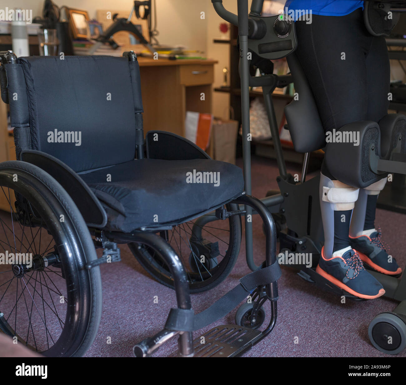 Woman with spinal cord injury getting into her desk so she can stand up ...