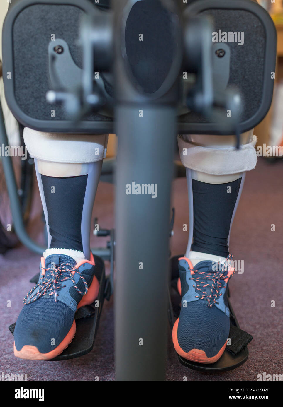 Latina woman with spinal cord injury getting into her desk so she can ...