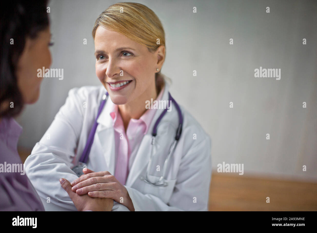 Doctor comforting patient Stock Photo - Alamy