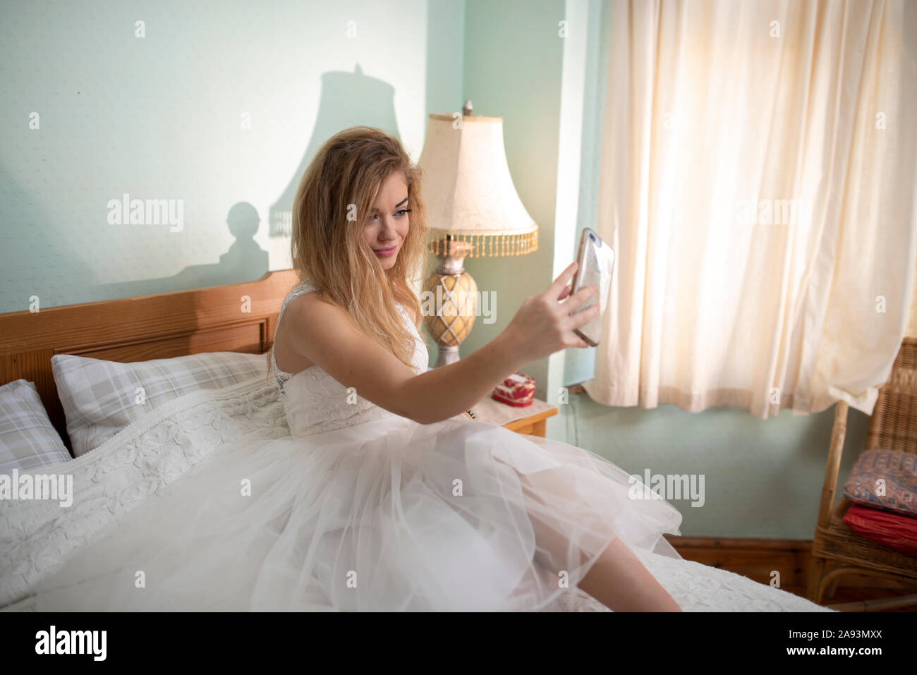 Young bride gets ready - morning sun and wedding day morning Stock ...
