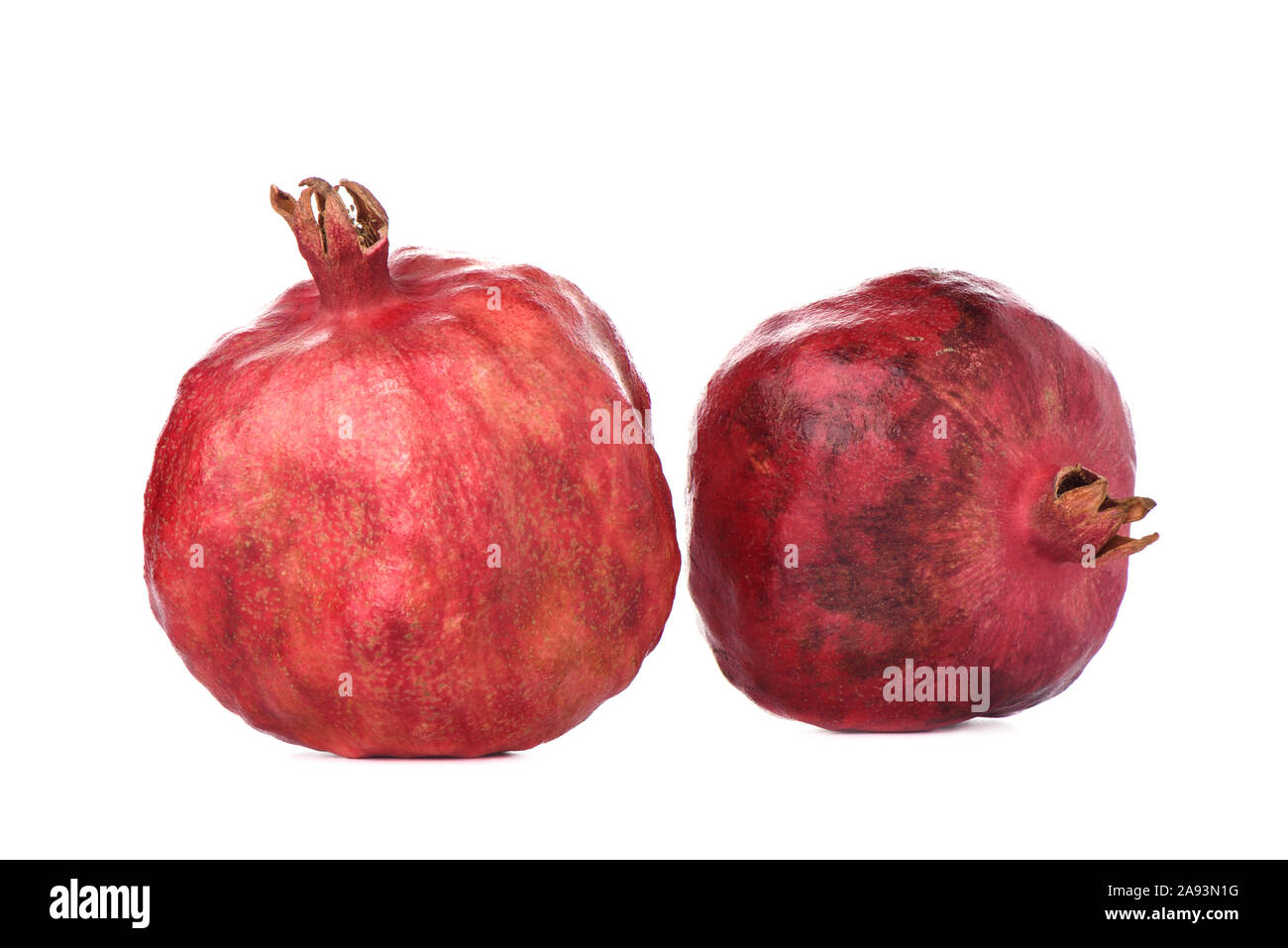 Two ripe pomegranates isolated on a white background. Close up. Copy ...