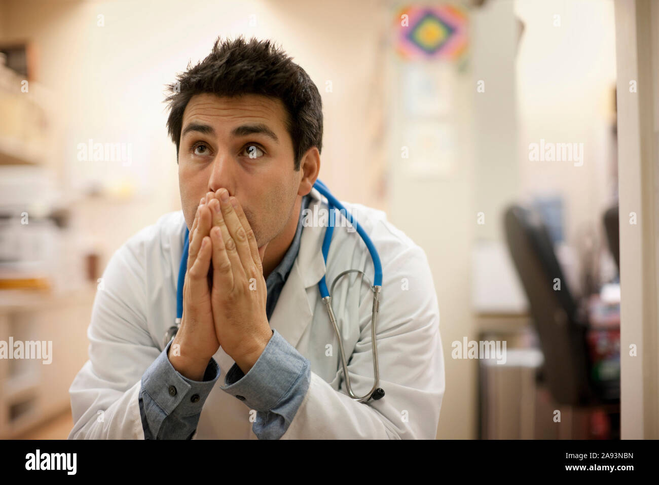 Anxious doctor sitting in his office Stock Photo - Alamy