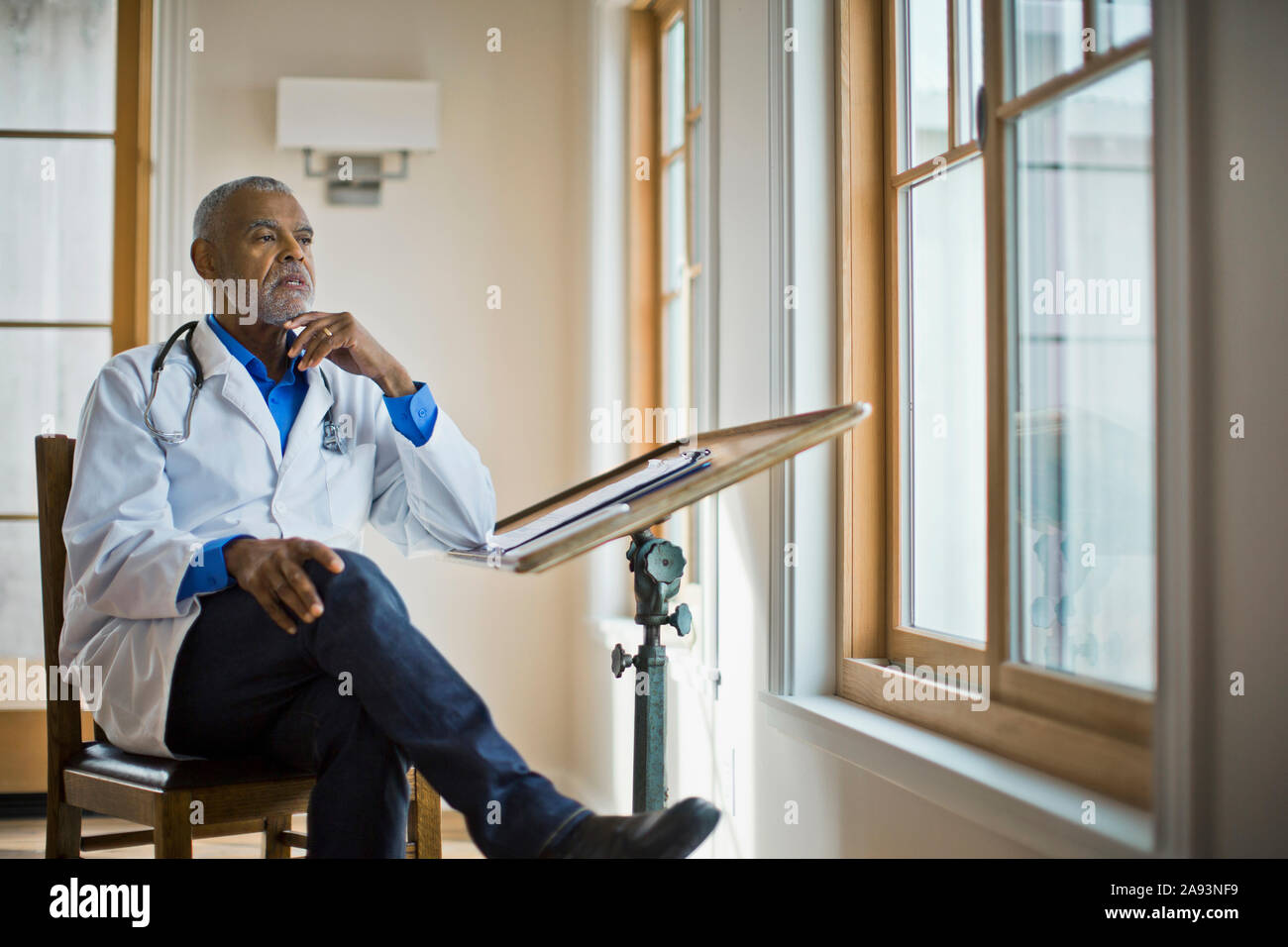 Doctor sitting and thinking Stock Photo - Alamy