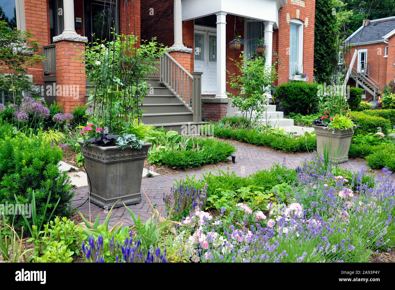 This beautiful, urban front yard garden features a large veranda, brick ...