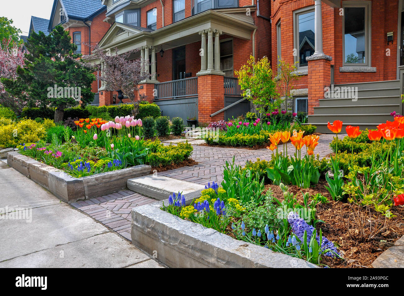 This beautiful, urban front yard garden features a large veranda, brick ...
