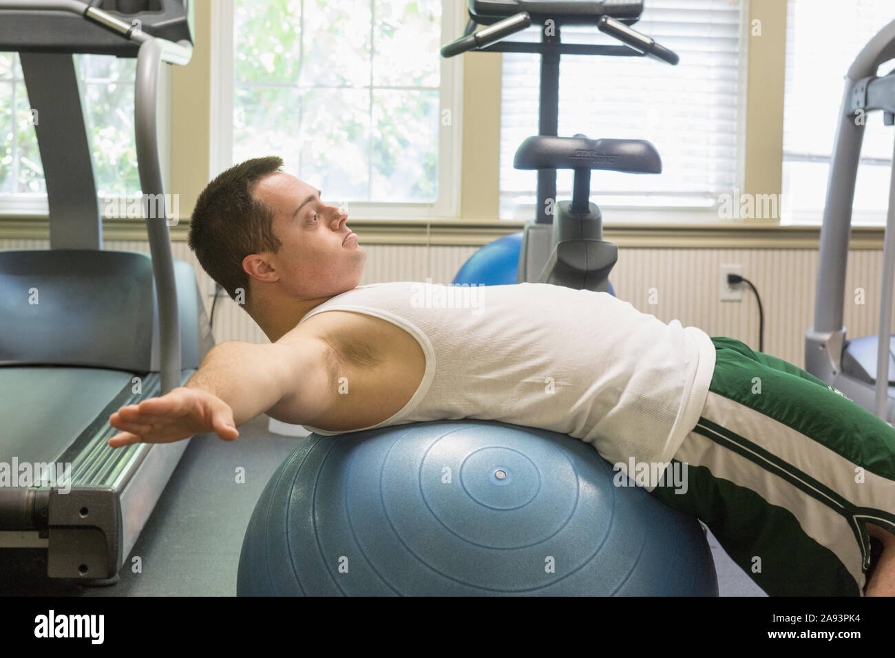 Man with Down Syndrome exercising in a gym Stock Photo - Alamy