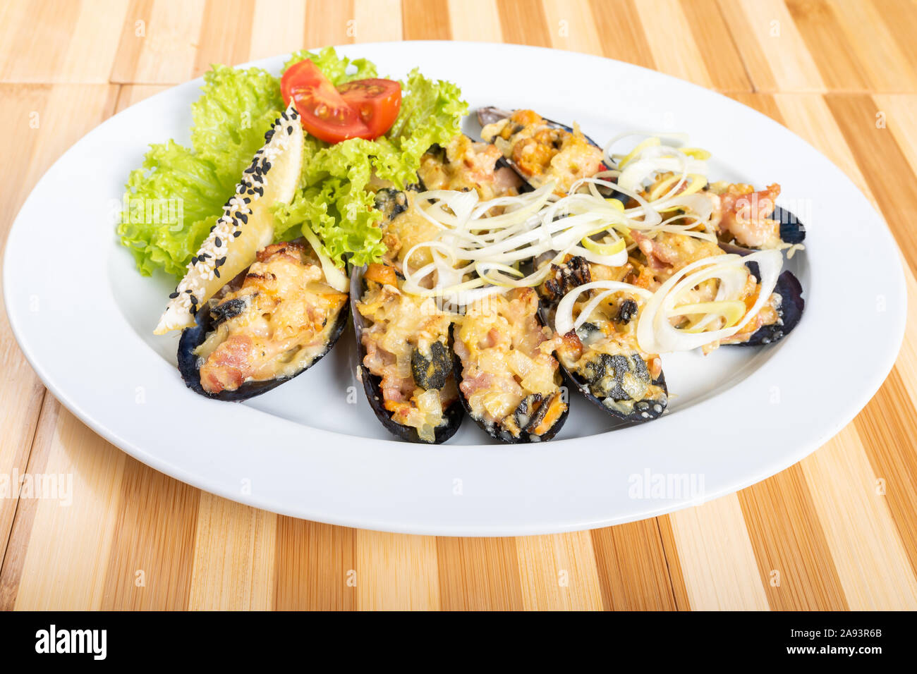 Baked mussels in half shell with filling and side dish Stock Photo - Alamy