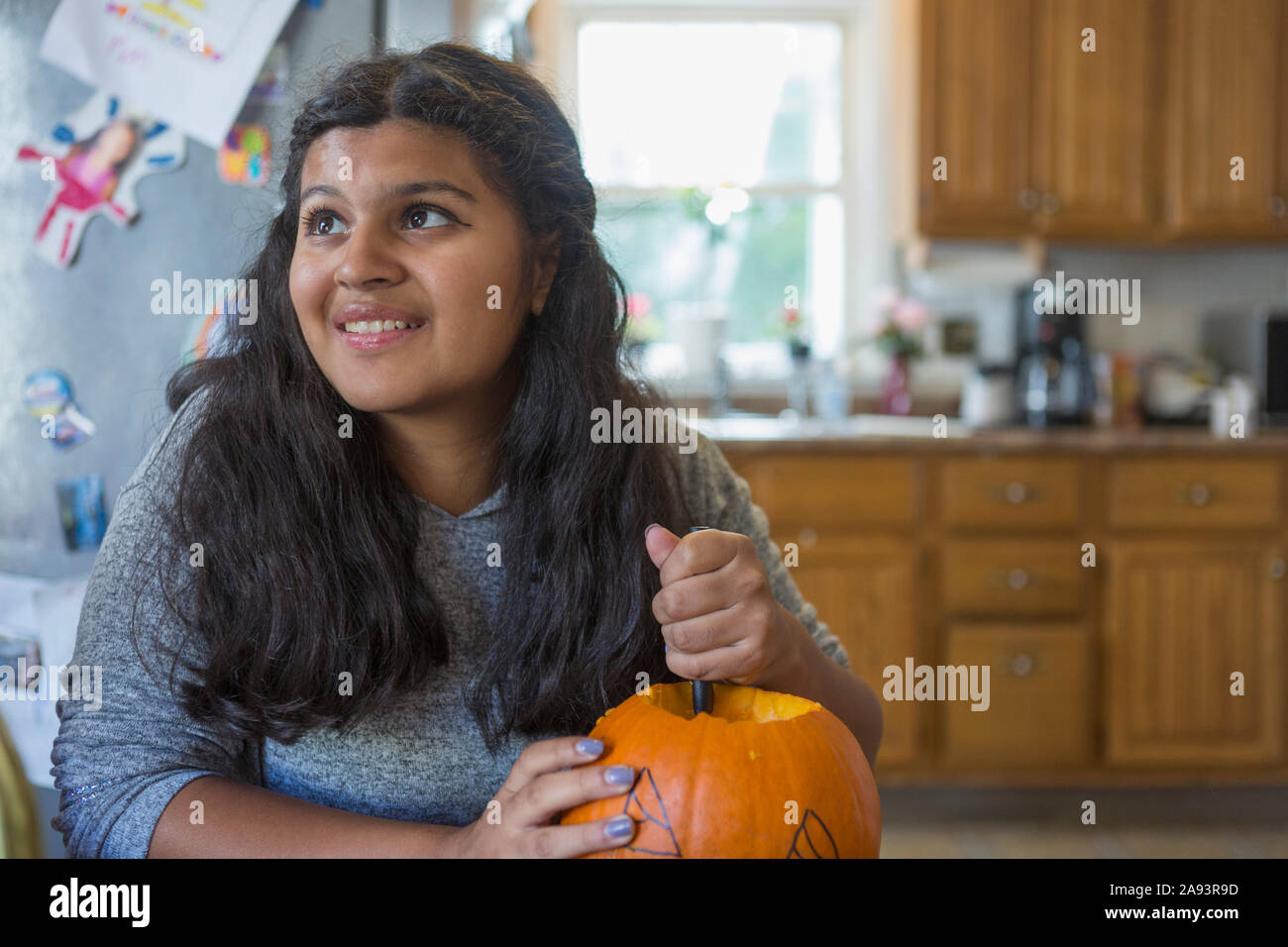 Teenager with Autism carving out a Halloween pumpkin Stock Photo - Alamy