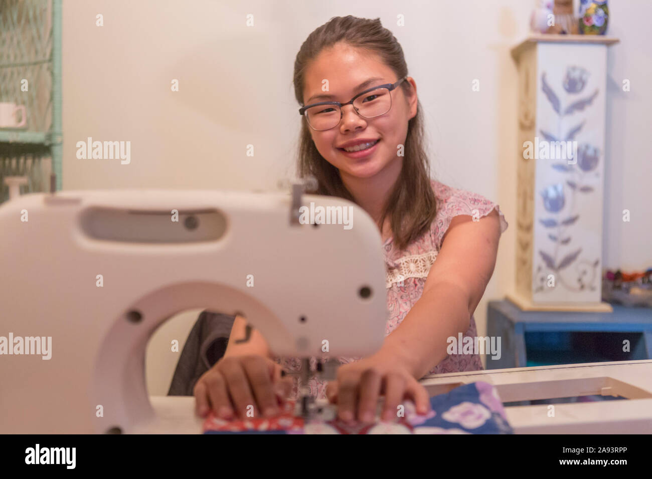 Teenage girl who has Learning Disability sewing clothes Stock Photo - Alamy