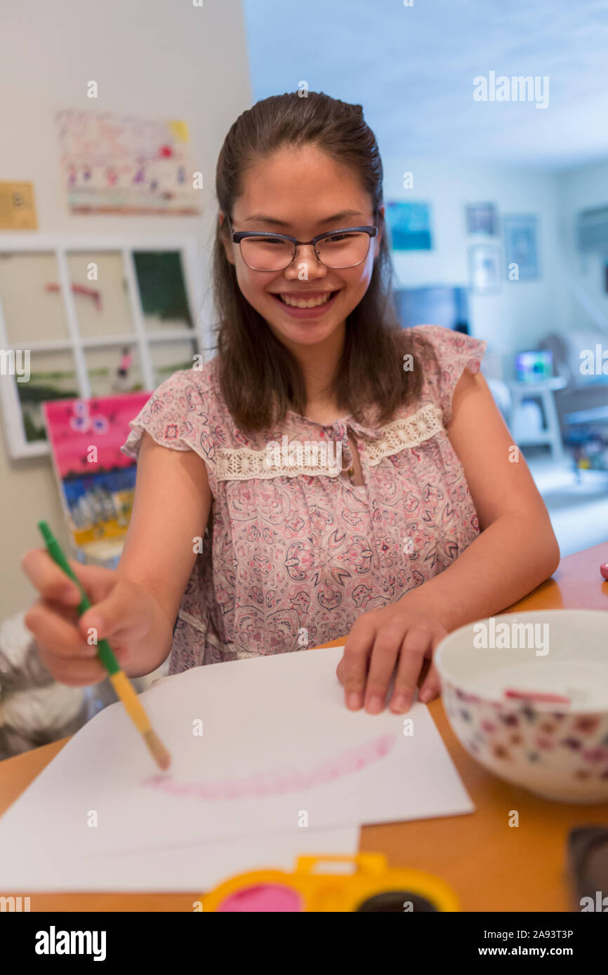 Teen girl with a Learning Disability using paints Stock Photo - Alamy