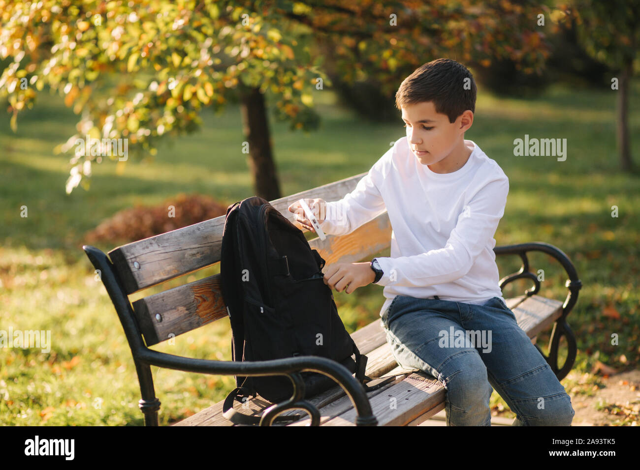 Handsome teenage boy take from his backpack powerbark for charging ...