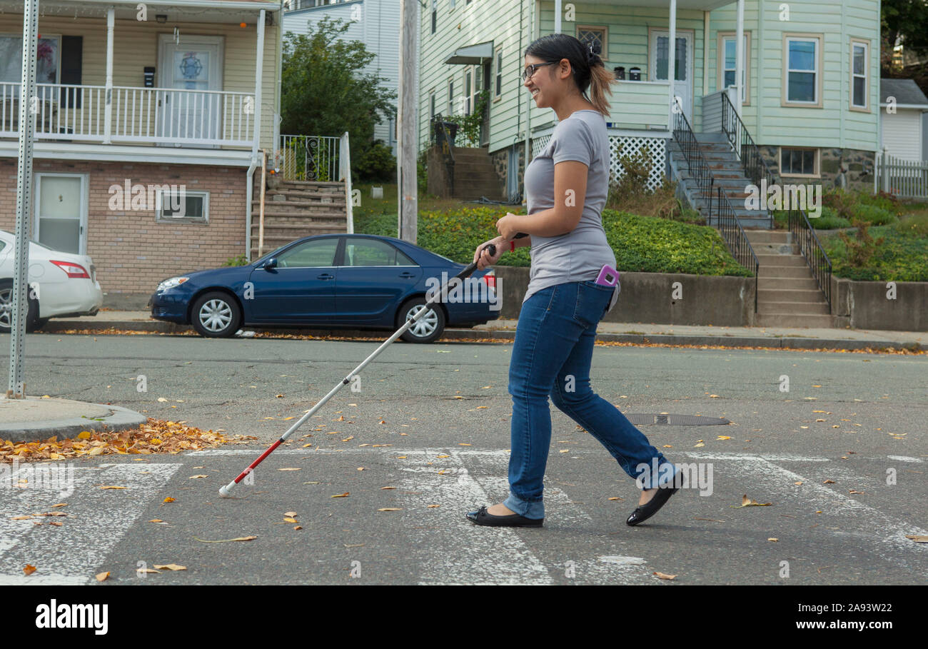 Woman with Visual Impairment walking on the road using her cane Stock ...