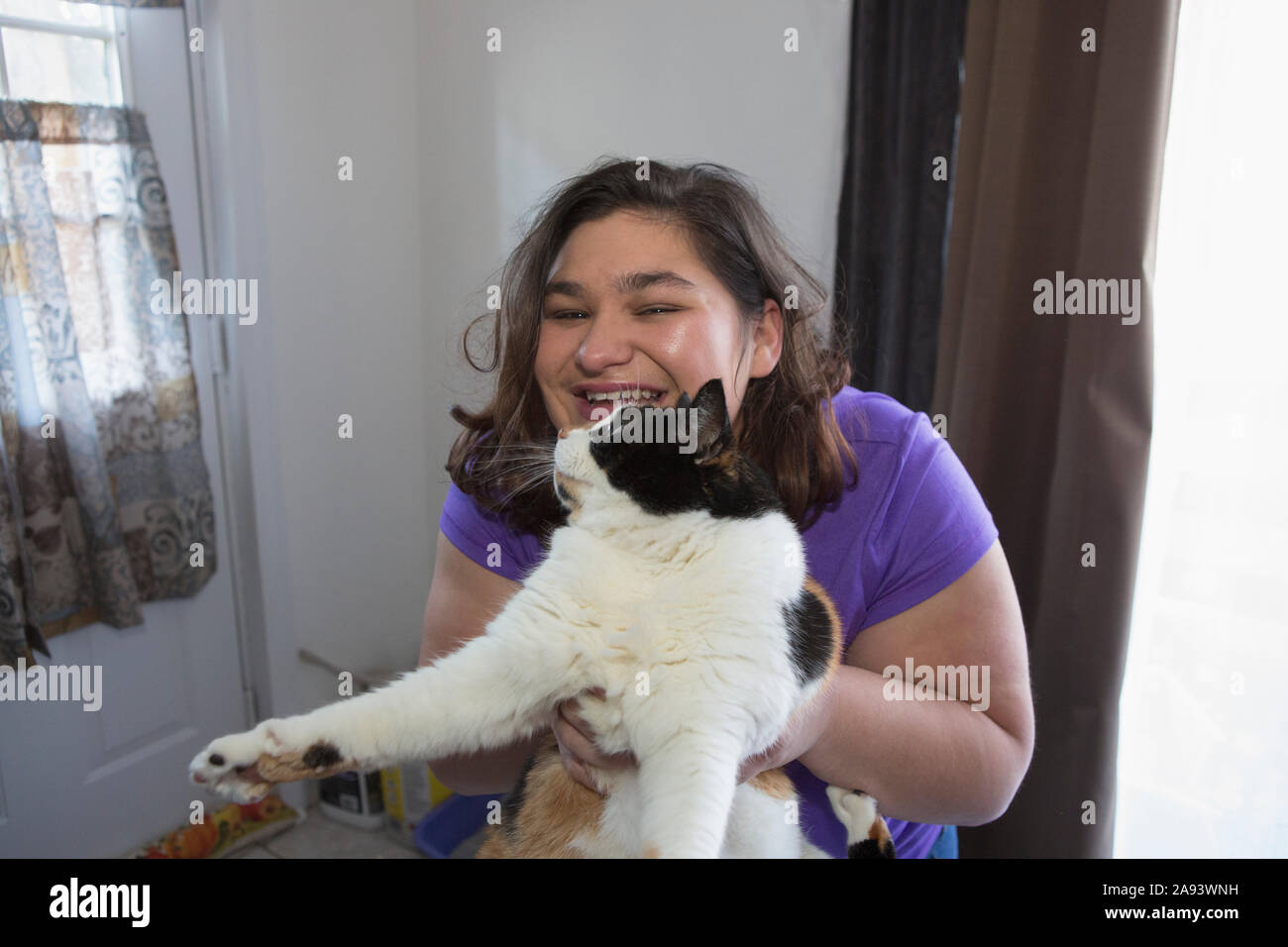 Girl with Cerebral Palsy with her cat Stock Photo - Alamy