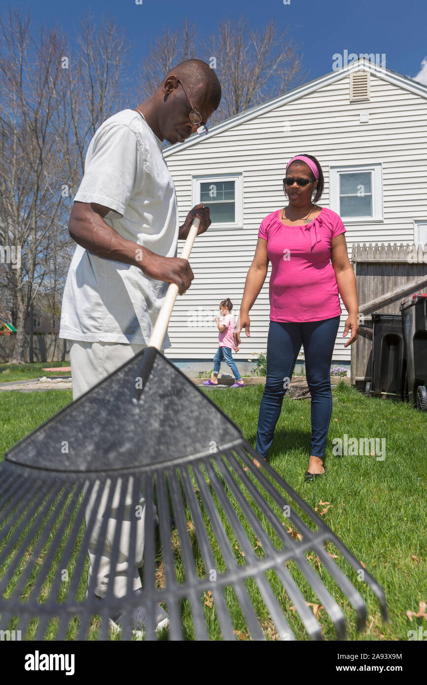 Man with Williams Syndrome raking leaves Stock Photo - Alamy
