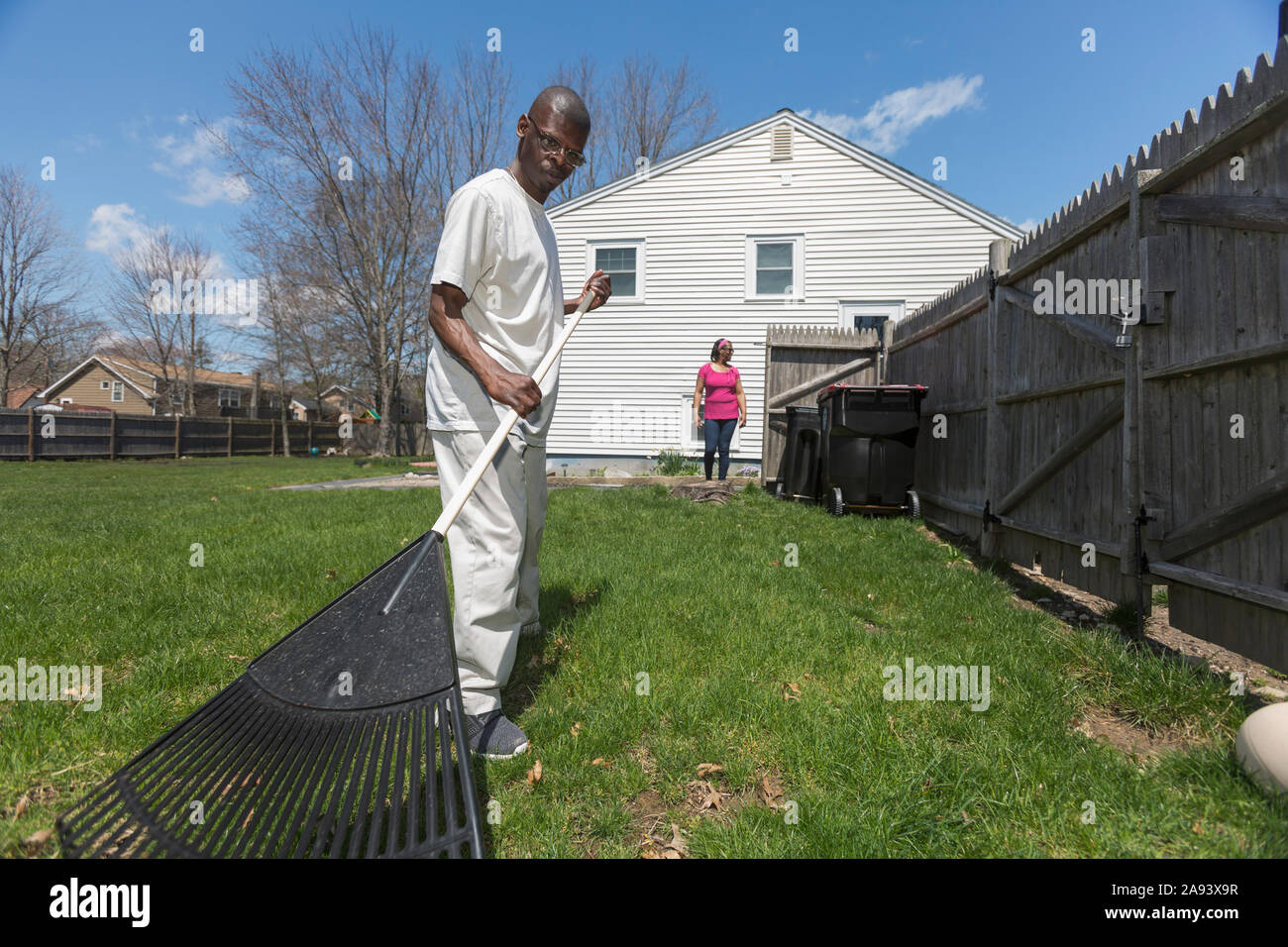 Man with Williams Syndrome raking leaves Stock Photo - Alamy