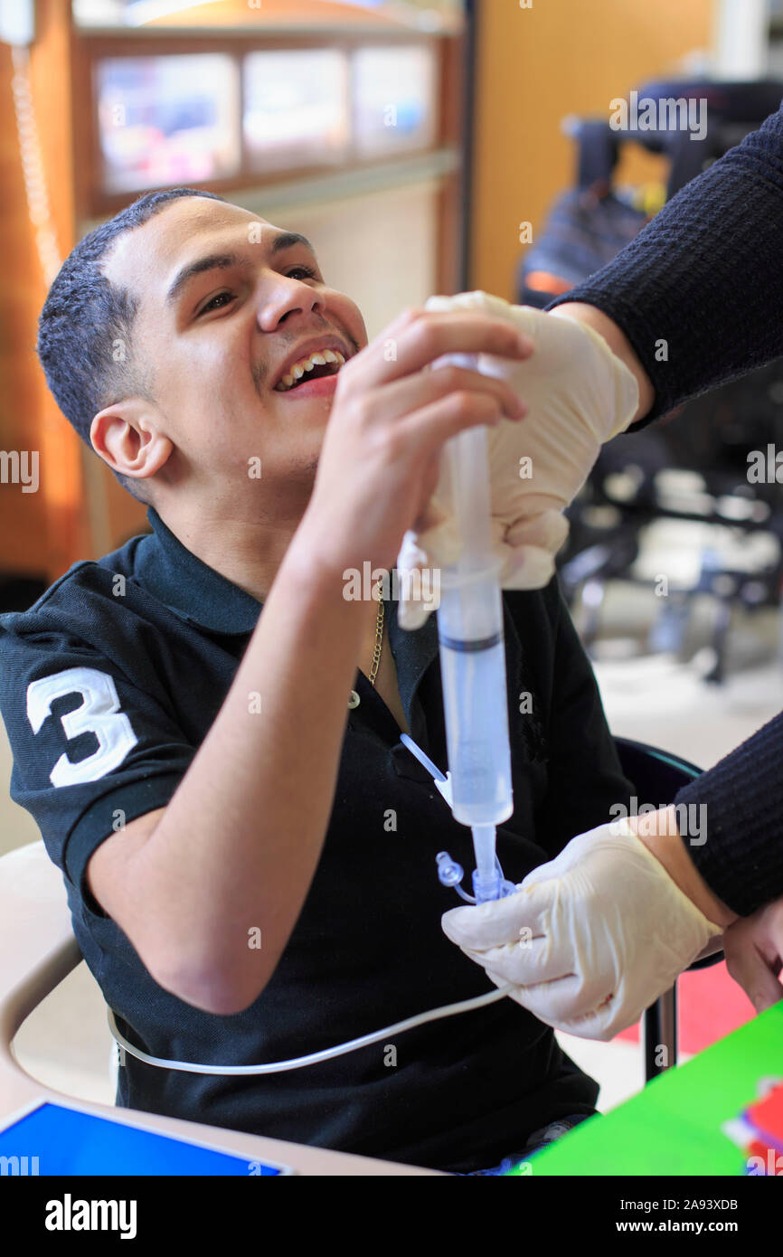 Boy with Spastic Quadriplegic Cerebral Palsy being fed at school Stock ...