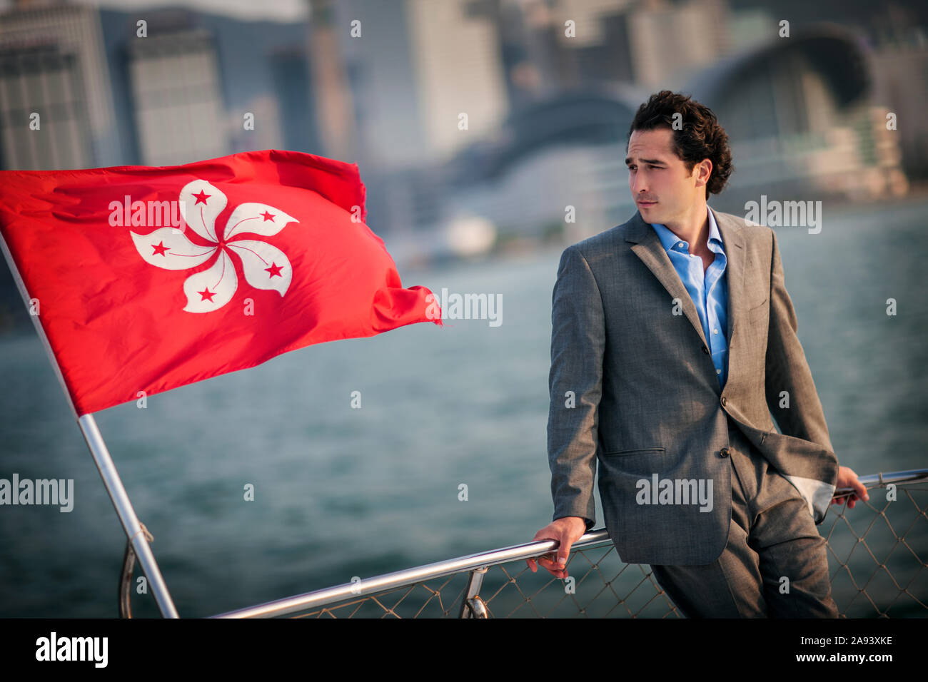 Mid adult man leaning against a boat railing looking thoughtful Stock ...