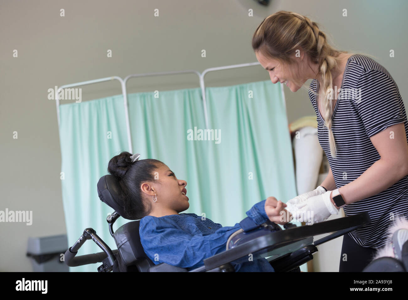 Teen with Spastic Dystonic Cerebral Palsy and assistant at school Stock ...