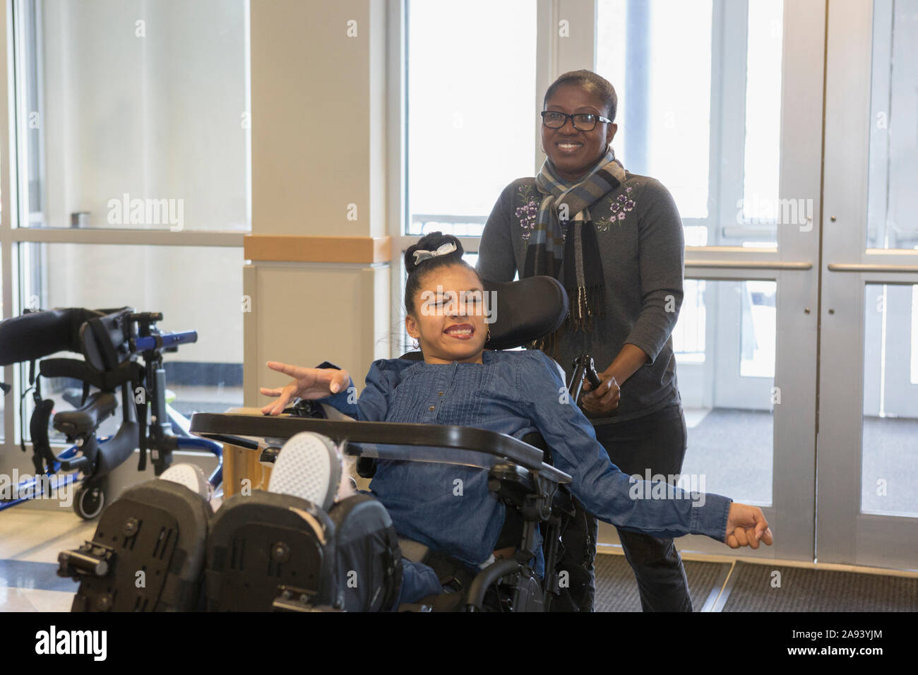Teen with Spastic Dystonic Cerebral Palsy and assistant at school Stock ...