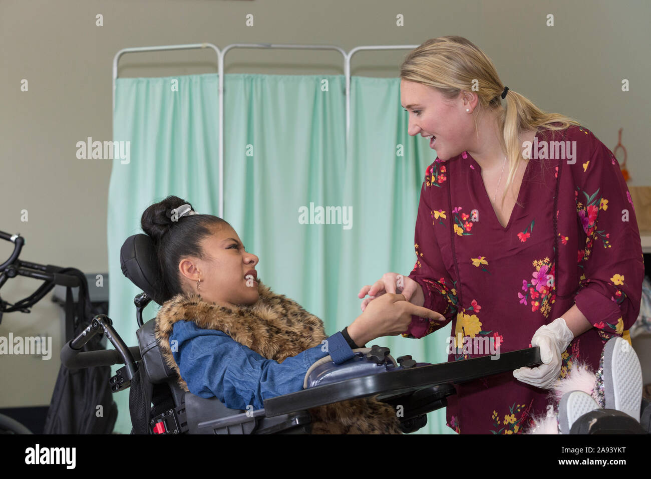 Teen with Spastic Dystonic Cerebral Palsy and assistant at school Stock ...