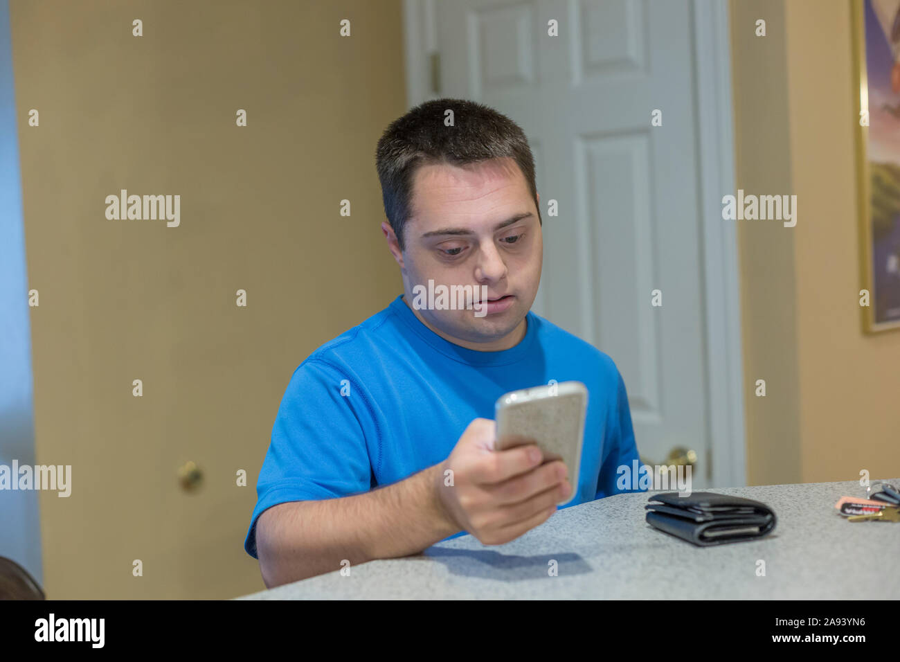 Man with Down Syndrome using a mobile phone Stock Photo - Alamy