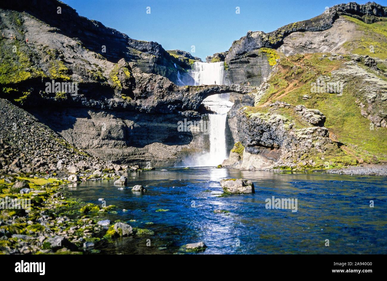 The Ófærufoss waterfall, Iceland 1984. Showing the famous rock arch (the Steinbogi) which ...