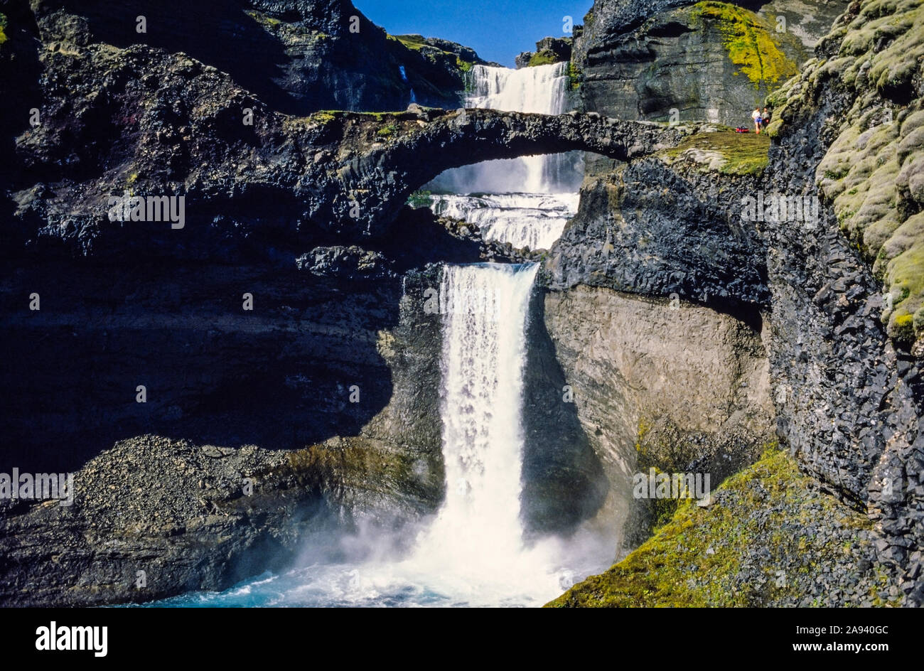 The Ófærufoss waterfall, Iceland 1984. Showing the famous rock arch (the Steinbogi) which ...