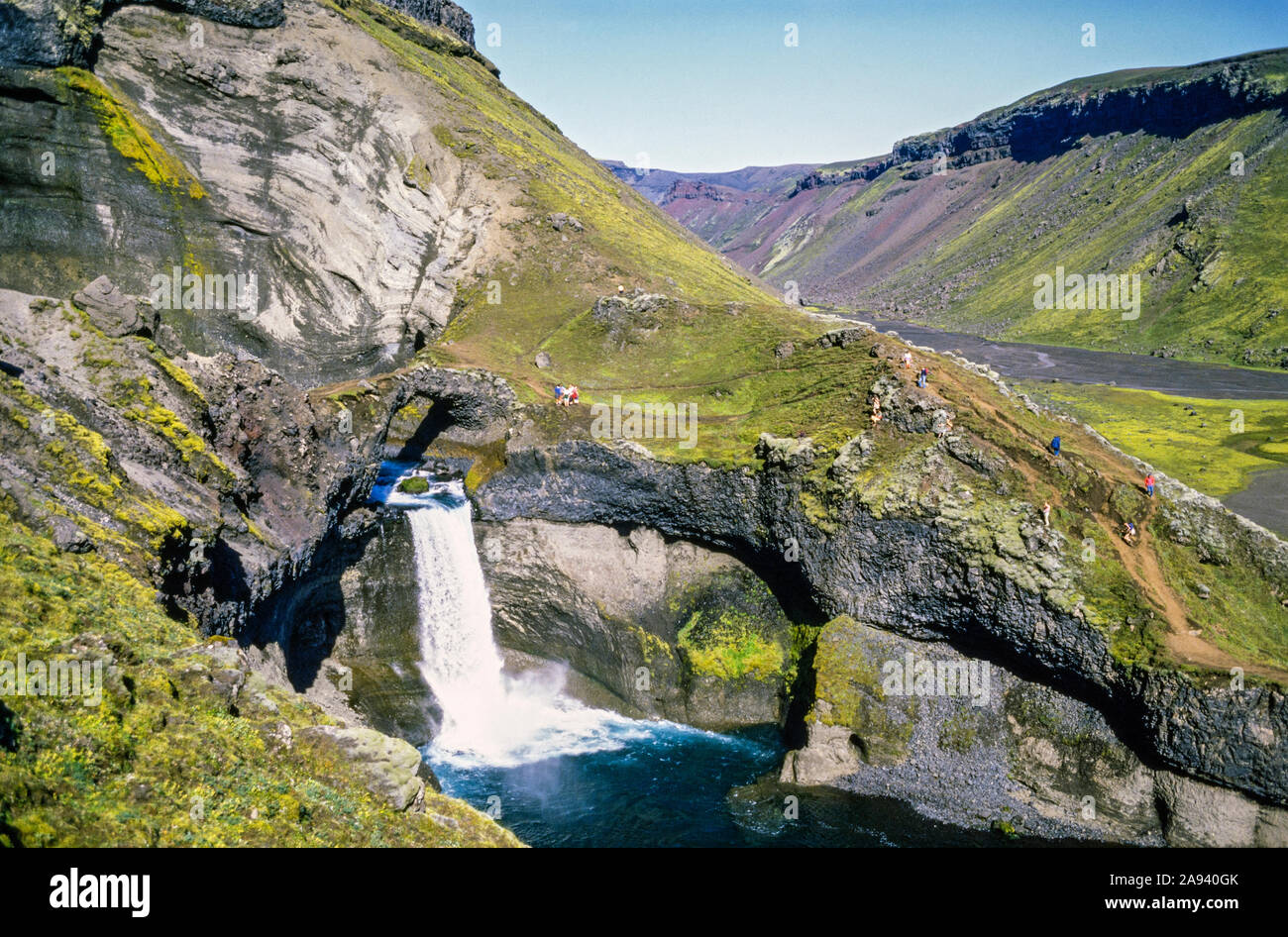 The Ófærufoss waterfall, Iceland 1984. Showing the famous rock arch (the Steinbogi) which ...