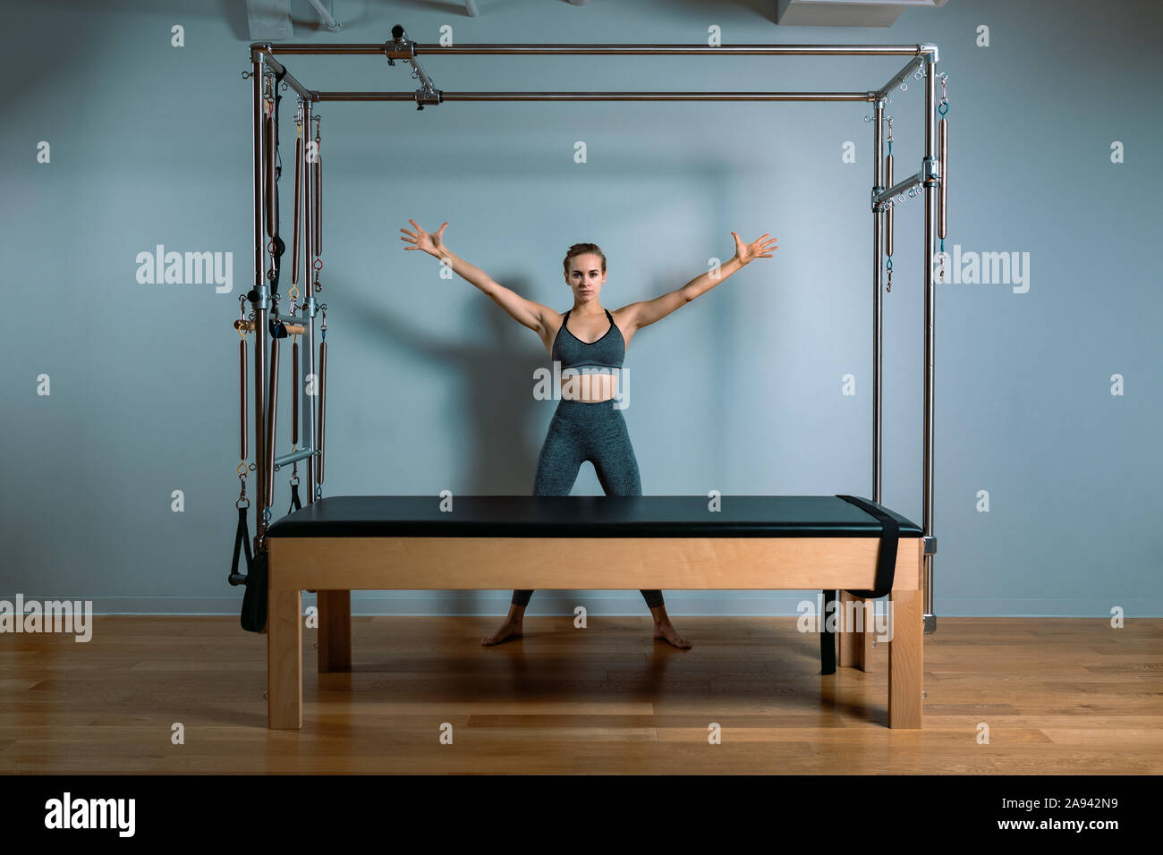 Palates trainer girl posing for a reformer in the gym. Fitness concept ...
