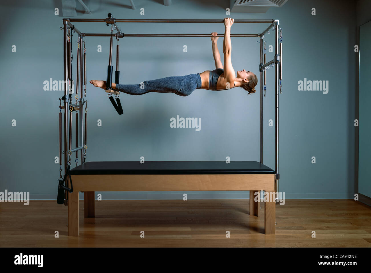 Palates trainer girl posing for a reformer in the gym. Fitness concept ...