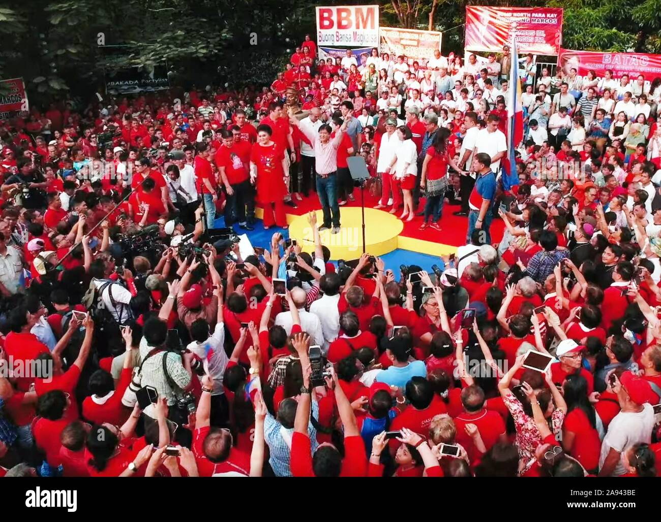 THE KINGMAKER, Imelda Marcos (in red dress and pants) attending a ...