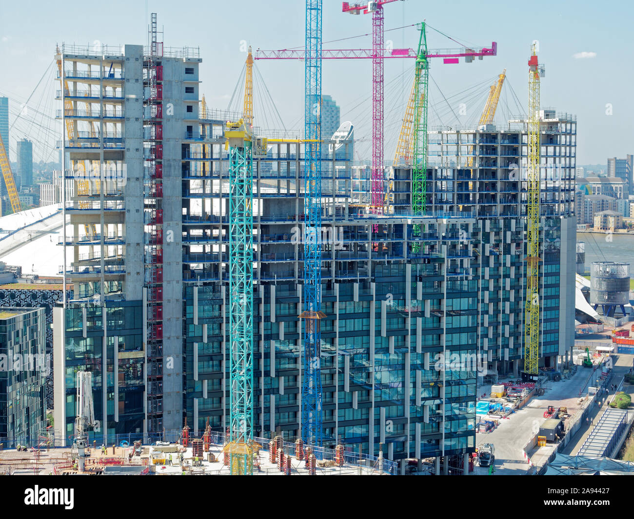 Colourful construction cranes on a building site near O2 Arena in ...