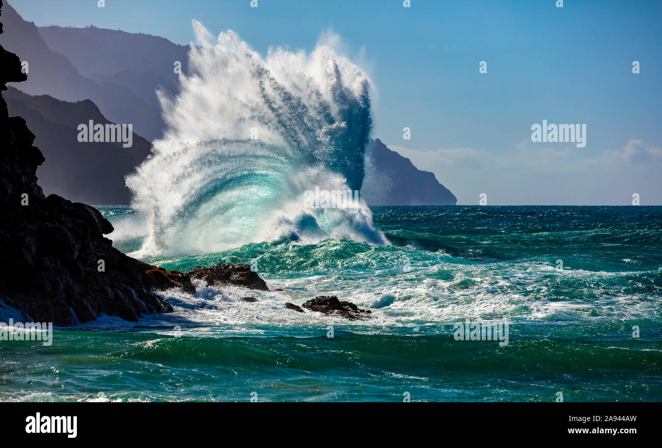 Large ocean wave crashes into rock along the Na Pali Coast; Kauai ...