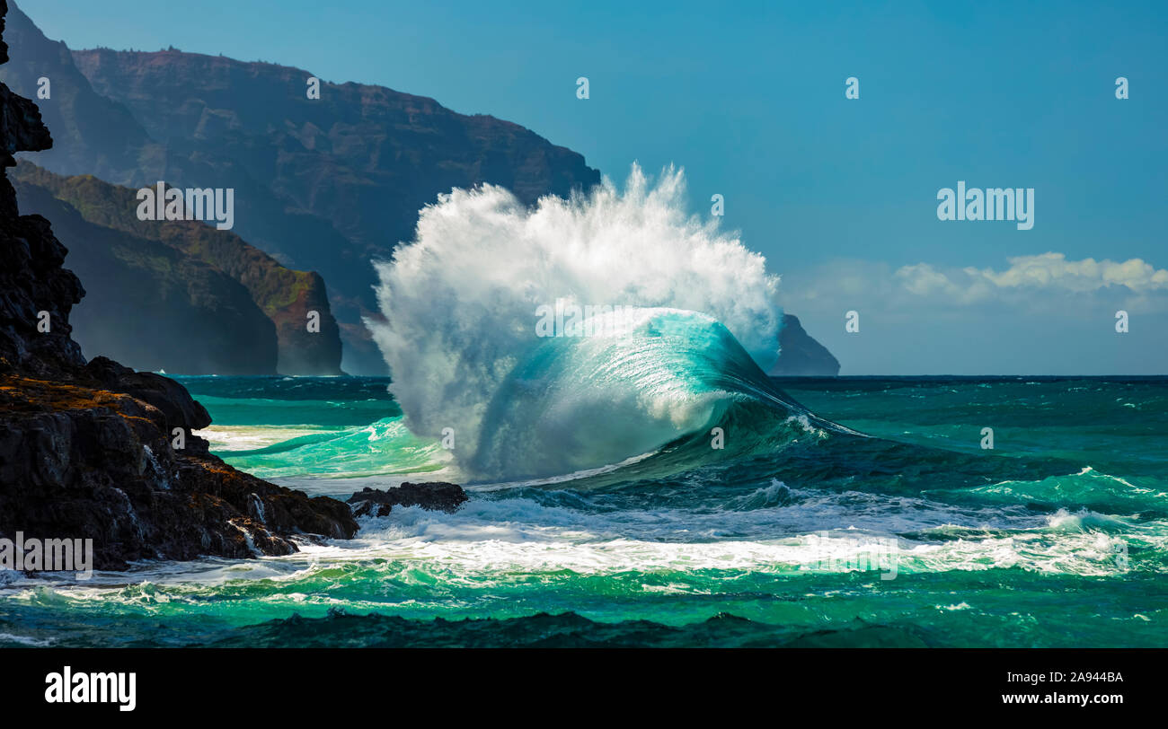 Large ocean wave crashes into rock along the Na Pali Coast; Kauai ...