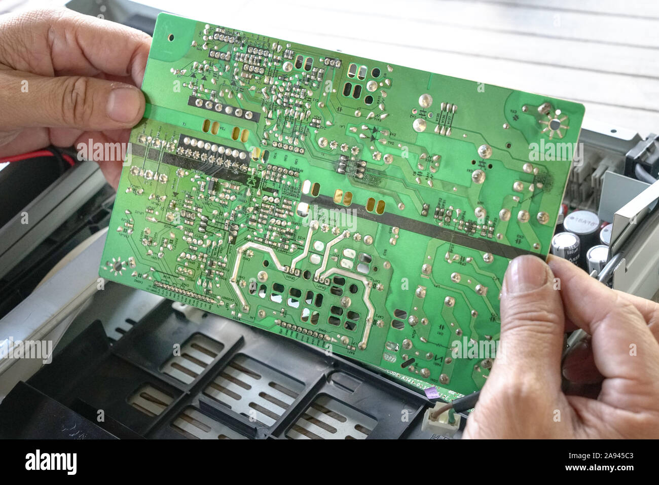 Hands holding PCB board while fixing faulty sound equipment Stock Photo ...