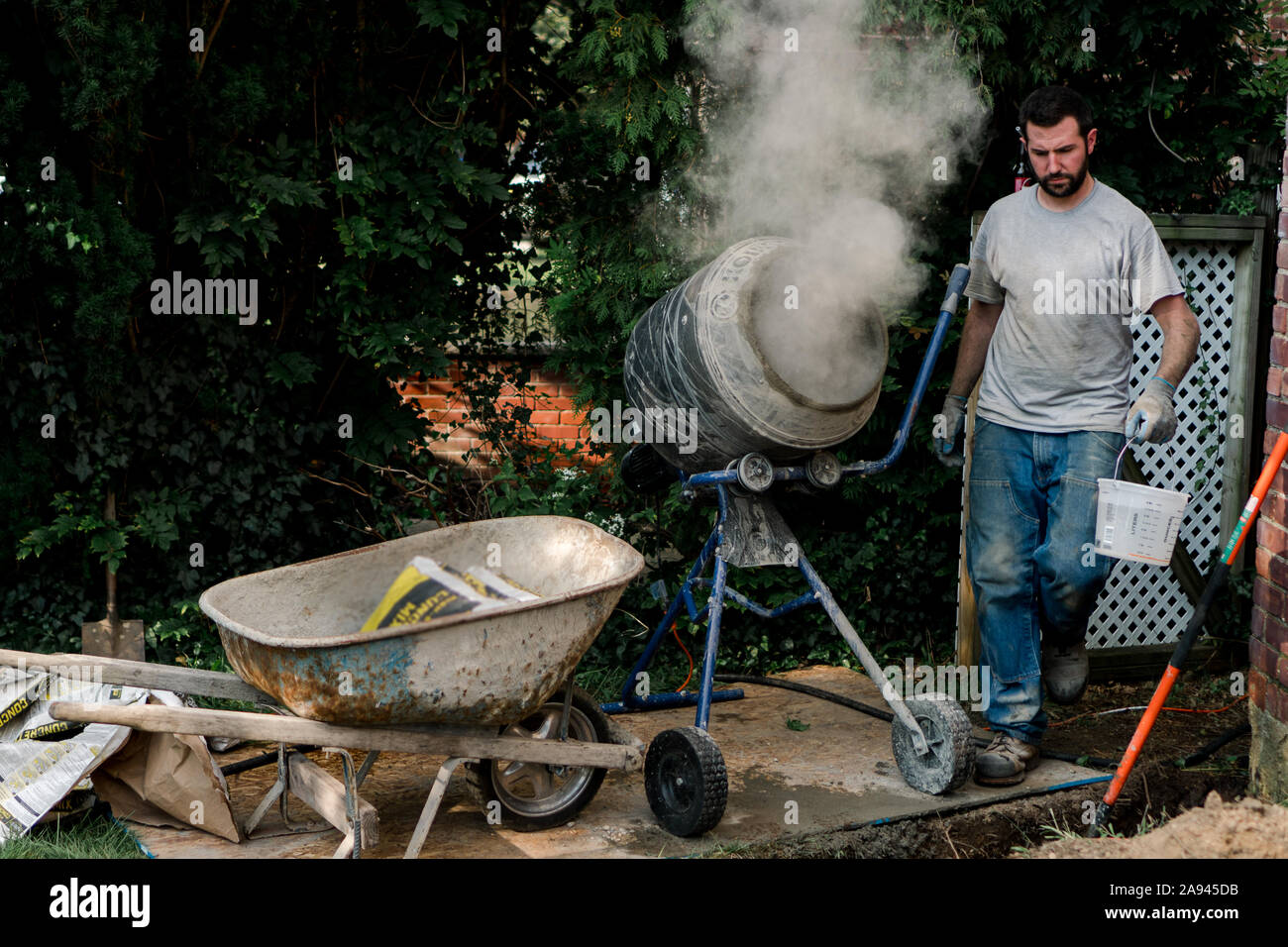 A man mixes some cement Stock Photo - Alamy